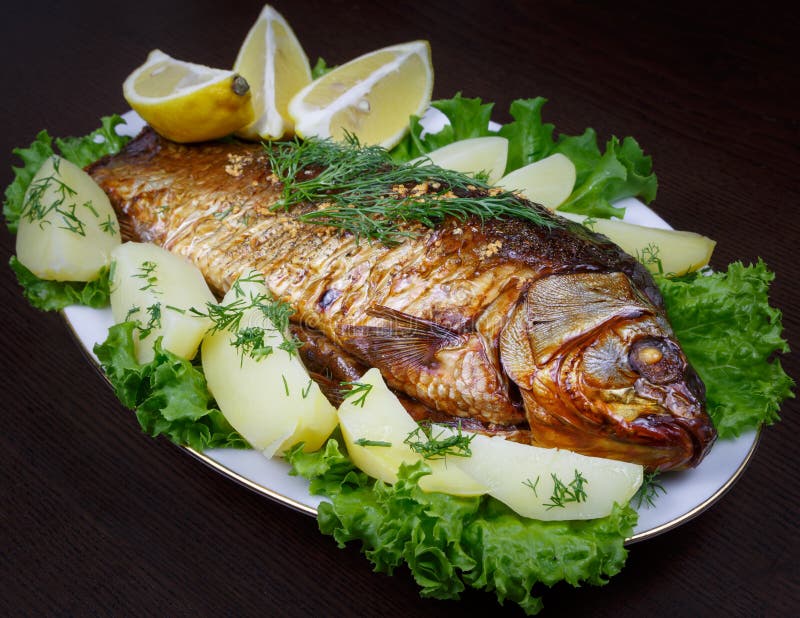 Carp Cooked in the Oven with Potatoes and Lemon Stock Image - Image of ...