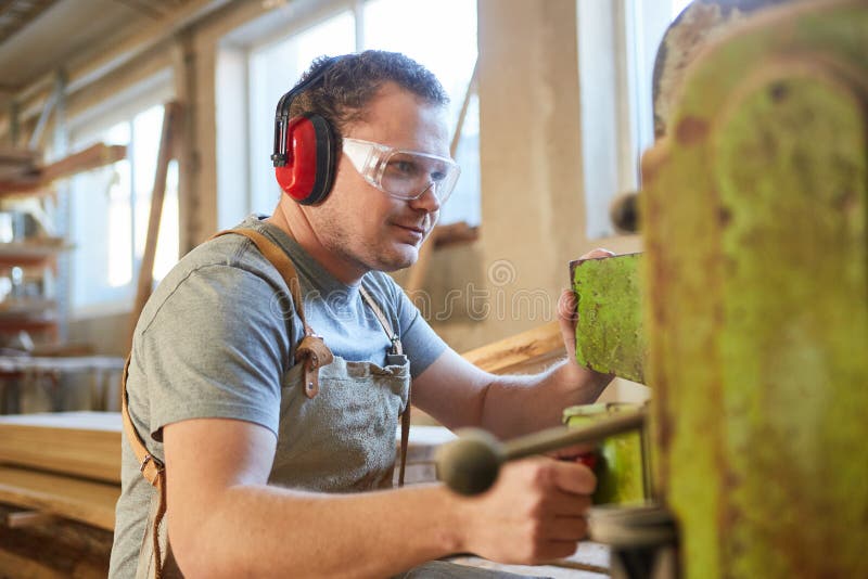 Carpenter Apprentice with Hearing Protection on a Machine Stock Photo ...