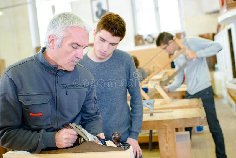 Carpenter and Apprentice in Workshop Stock Image - Image of carpentry ...