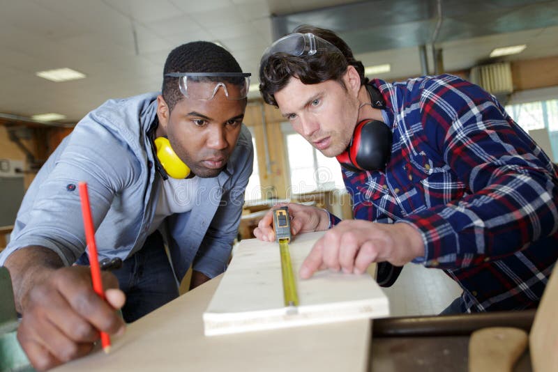 Carpenter and Apprentice Working in Studio Stock Photo - Image of ...