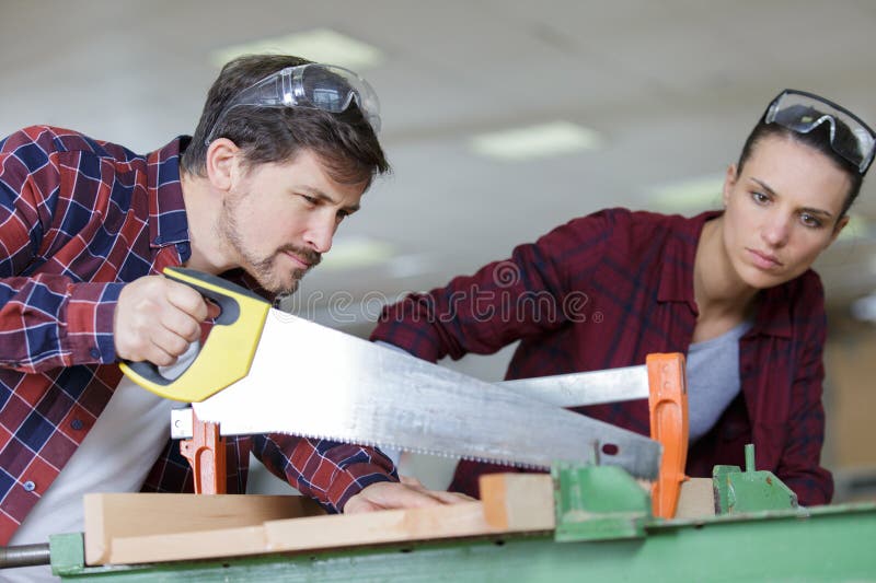Carpenter and Apprentice Working Together in Wood Workshop Stock Image ...