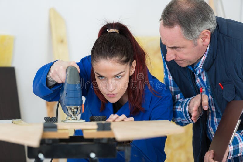 Carpenter and Apprentice Working Together in Workshop Stock Image ...