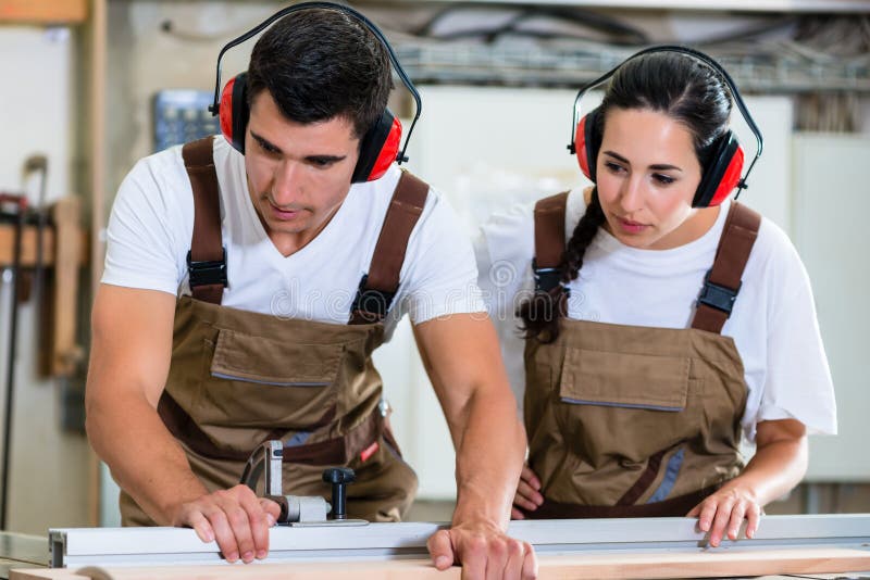 Carpenter and Apprentice Working Together in Workshop Stock Photo ...