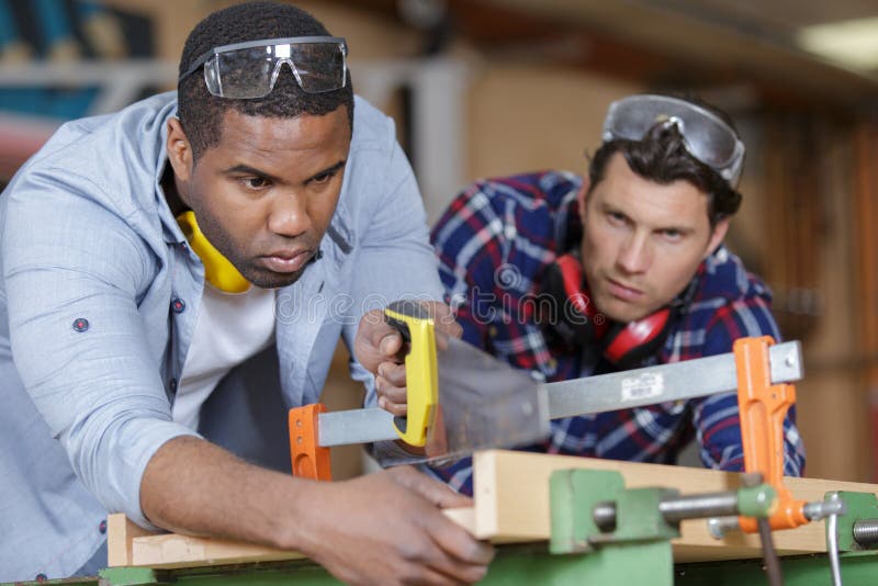 Carpenter with Apprentices Finishing Wood in Workshop Stock Image ...