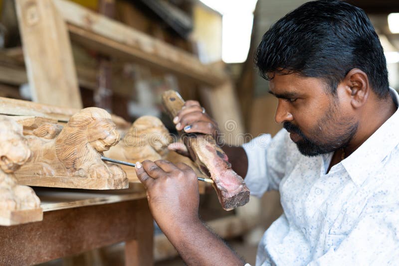 Focus on Carpenter, Young Indian Carpenter Polising or Shaping Chariot ...