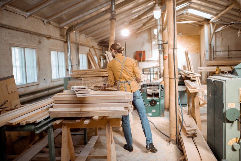 Carpenter Carrying Pine Planks in the Warehosue Stock Photo - Image of ...