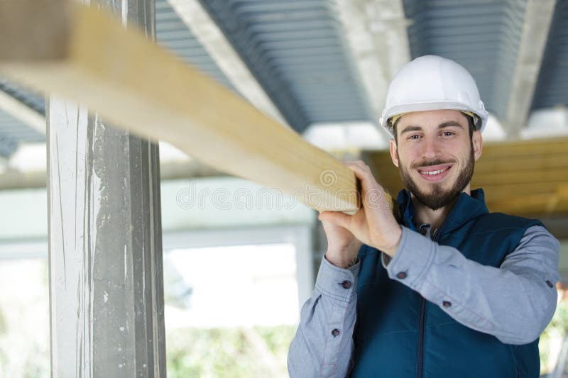 Carpenter Carrying Timber Plank at Construction Site Stock Image ...