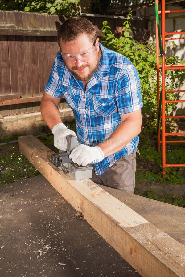 Carpenter Chipping the Wooden Plank Stock Image - Image of shirt ...