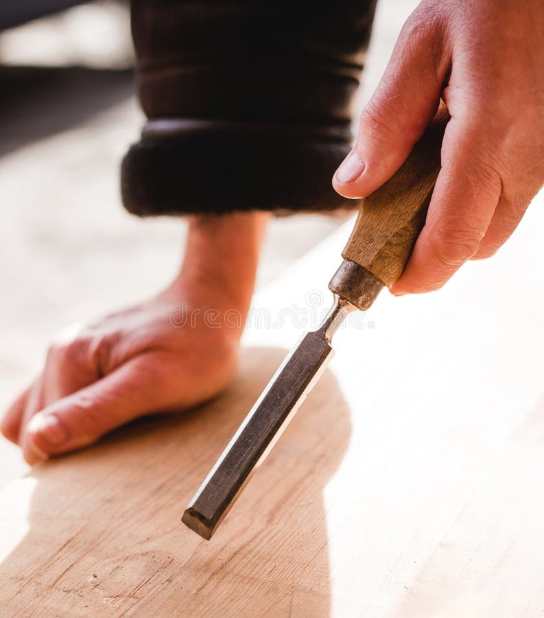 Carpenter with Chisel in the Hands on the Workbench in Carpentry, Close ...