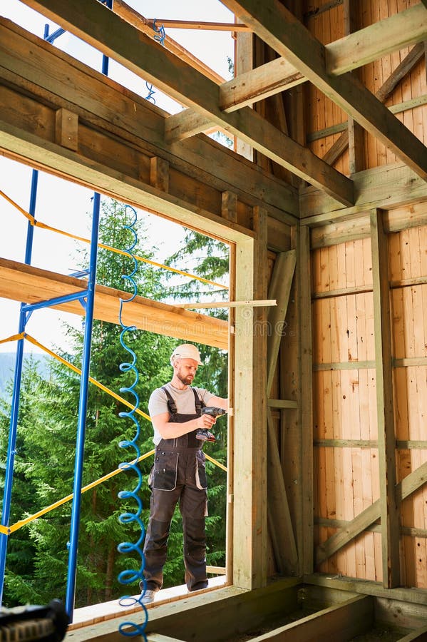 Carpenter Working with Screwdriver while Constructing Wooden Framed ...