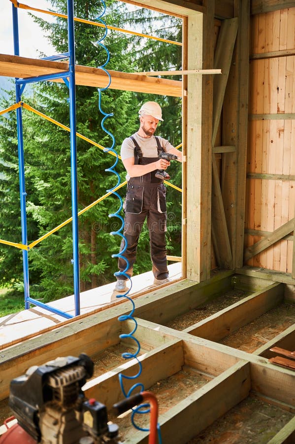 Carpenter Working with Screwdriver while Constructing Wooden Framed ...