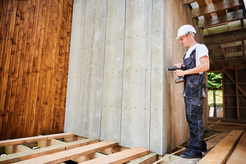Carpenter Working with Screwdriver while Constructing Wooden Framed ...