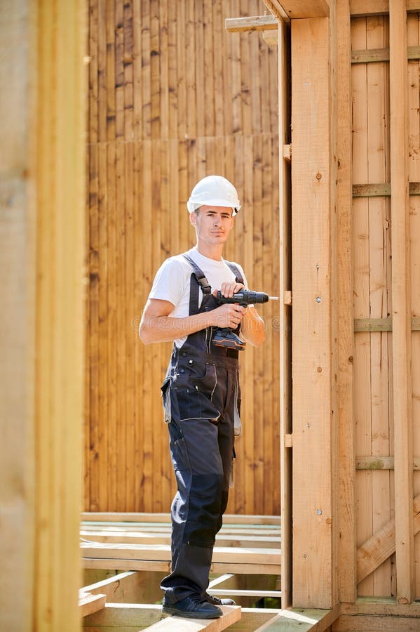 Carpenter Working with Screwdriver while Constructing Wooden Framed ...
