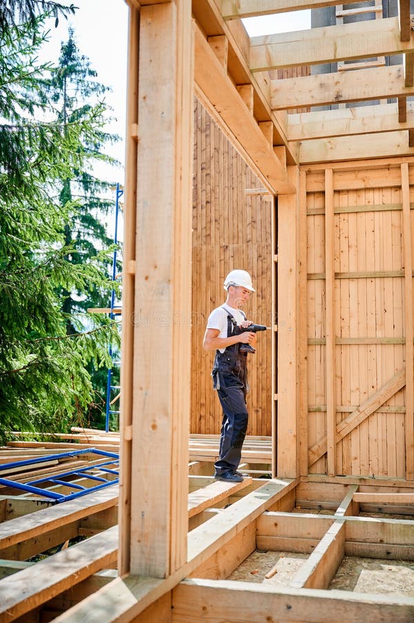 Carpenter Working with Screwdriver while Constructing Wooden Framed ...