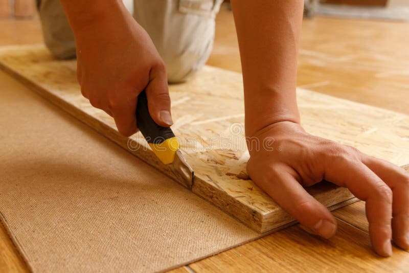 Carpenter Cuts Fiberboard with a Mounting Knife Using OSB Stock Image ...