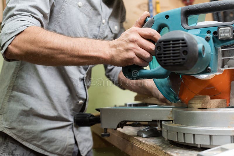 The Carpenter Cuts with a Miter Saw Stock Photo - Image of machine ...