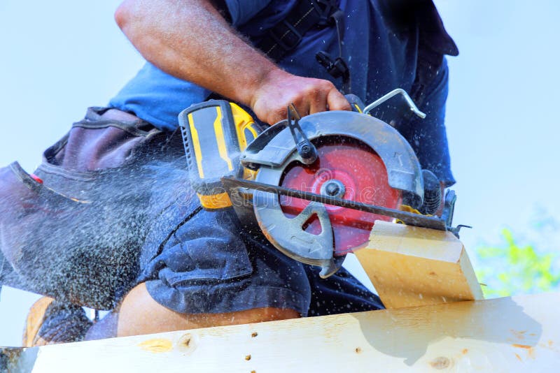 Skilled Carpenter Using Circular Saw To Cut Wood at Construction Site ...
