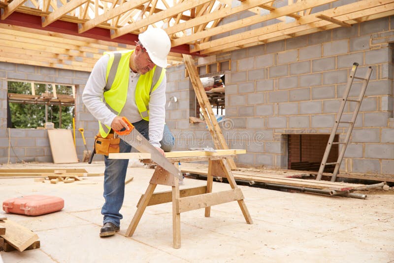 Man Carpenter Cutting Wood Using Table Saw at Construction Site Stock ...