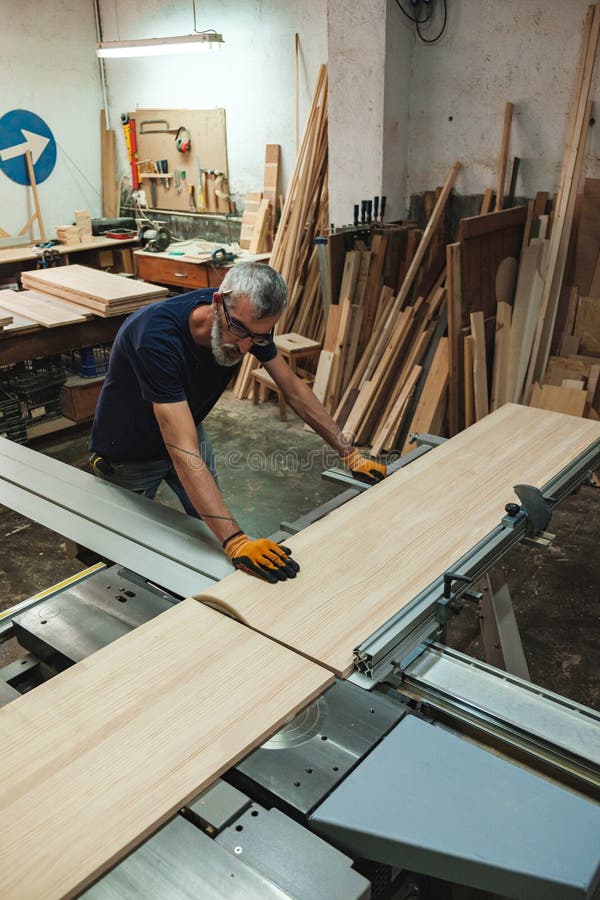 Carpenter Handling Large Pieces of Wood on an Industrial Cutting ...