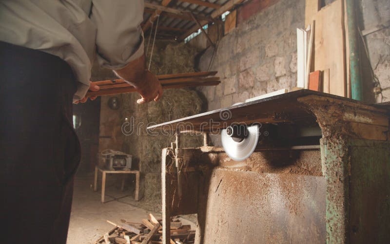 Carpenter Cutting a Piece of Wood with a Carpentry Machine Stock Photo ...