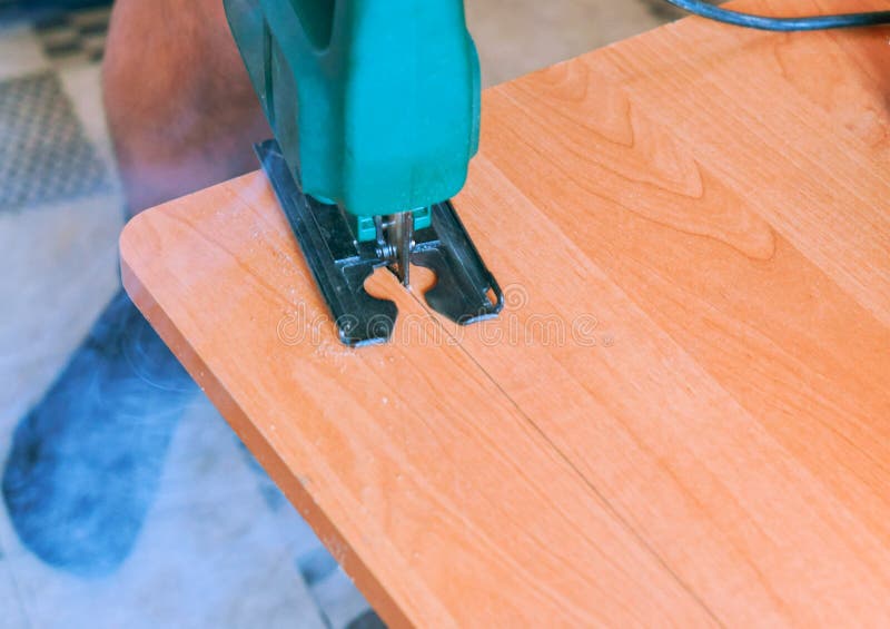 A Carpenter with a Cutting Tool, Man Works As a Jigsaw on a Tree Stock ...