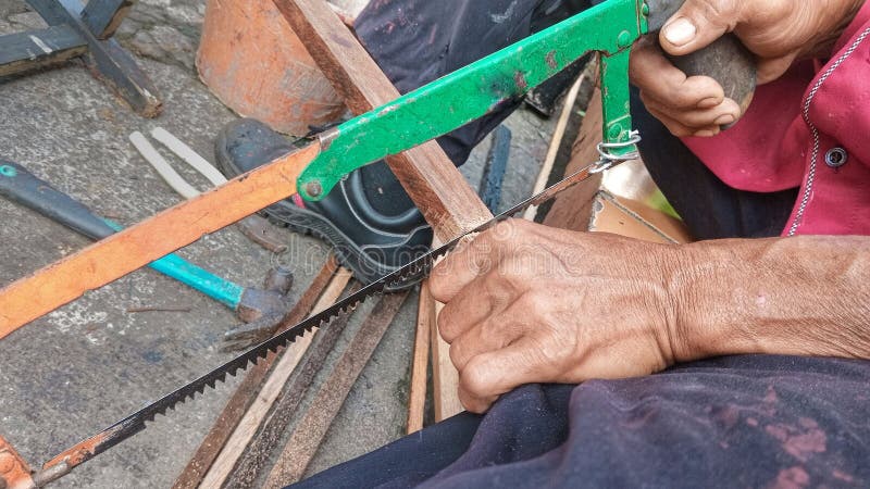 A Carpenter is Cutting Wood Using a Chainsaw Stock Photo - Image of ...