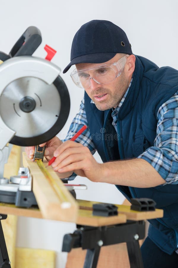 Carpenter Cutting Wood Using Drop Saw Stock Photo - Image of dust ...