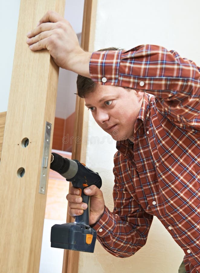 Carpenter at Door Lock Installation Stock Photo - Image of builder ...