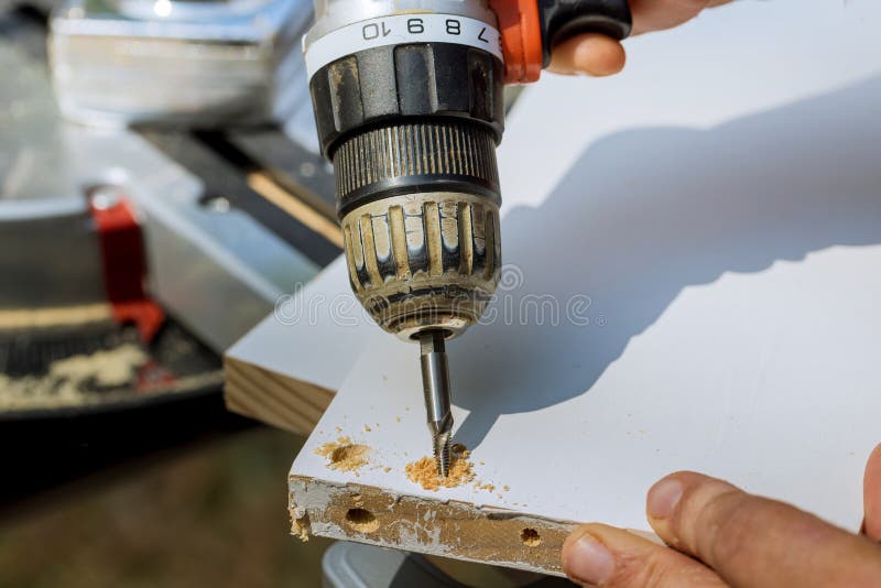 Carpenter Drilling Wood Boards into the Using a Screwdriver for the ...