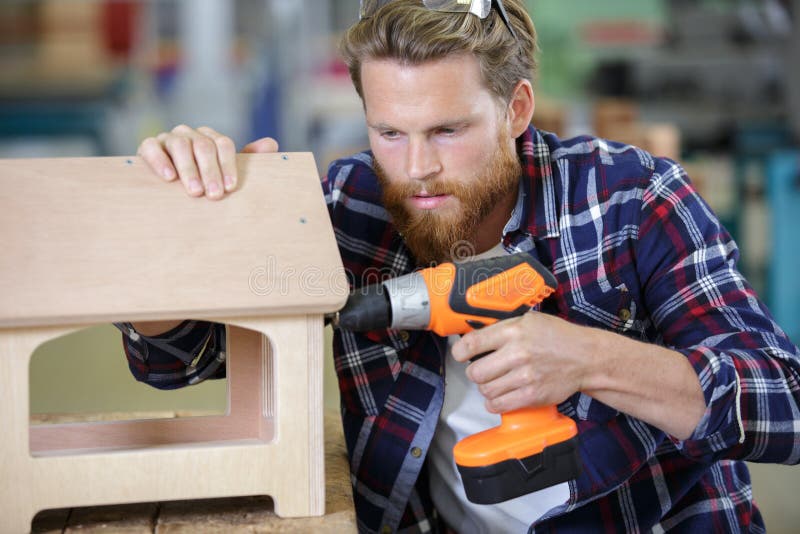 Carpenter Drilling Wood Using Driver Machine Stock Photo - Image of ...