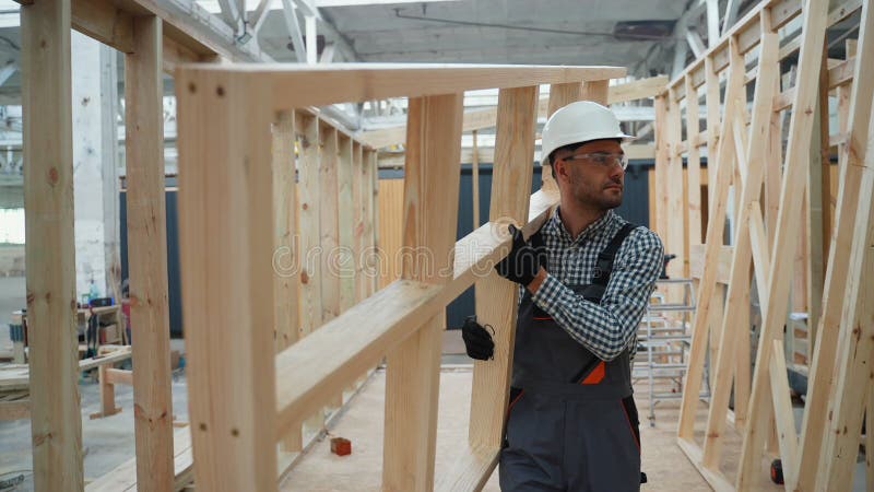 Carpenter Engineer in Uniform Walks with Frame through Unfinished ...