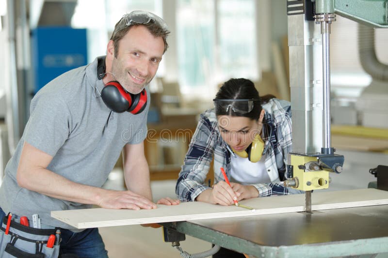 Carpenter with Female Apprentice Working on Building Site Stock Image ...