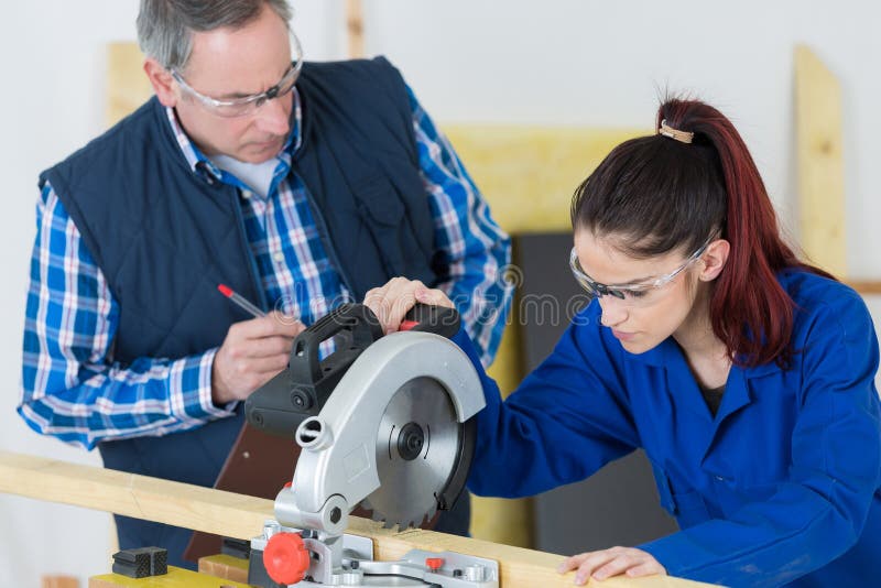 Carpenter with Female Apprentice Working on Building Site Stock Image ...