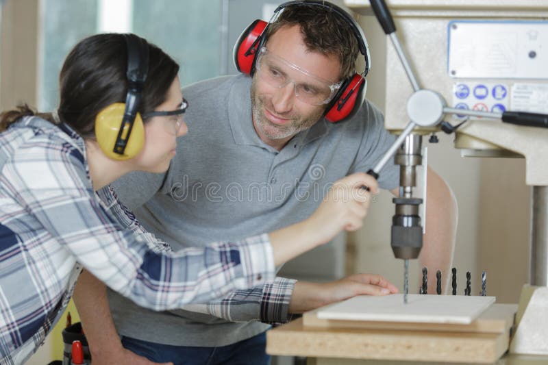 Carpenter with Female Apprentice Working on Building Site Stock Photo ...