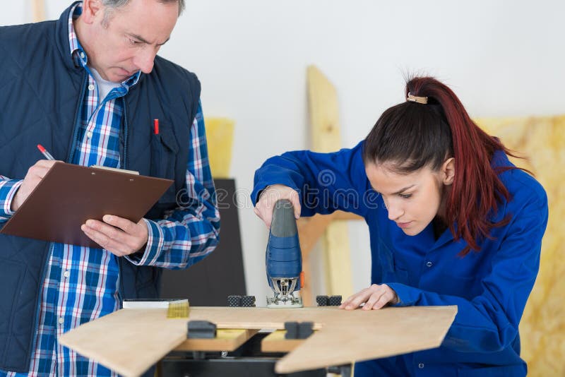 Carpenter with Female Apprentice Working on Building Site Stock Image ...
