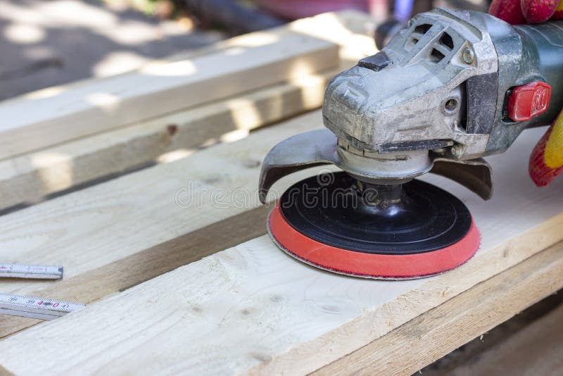 A Carpenter Grinds an Oak Plank Part with a Hand Grinder Stock Photo ...