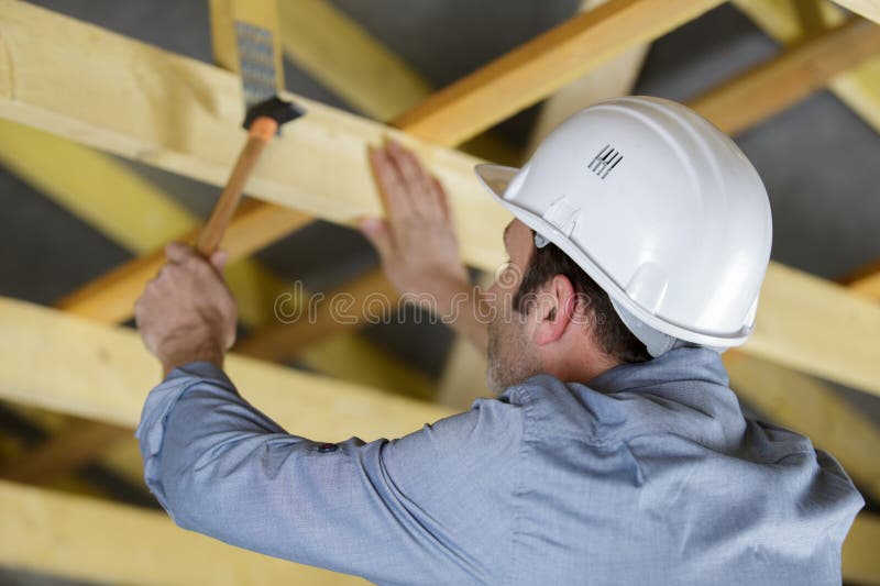 Carpenter with Hammer Hitting Nails Stock Photo - Image of beam ...