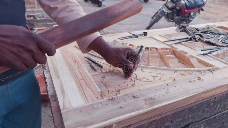 Carpenter Hand Drawing on Wood at a Workshop with Tools in Background ...