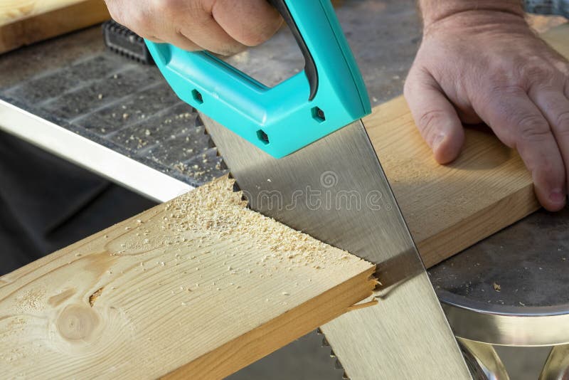 Carpenter Hand with Handsaw Cutting Wooden Boards. Stock Image - Image ...