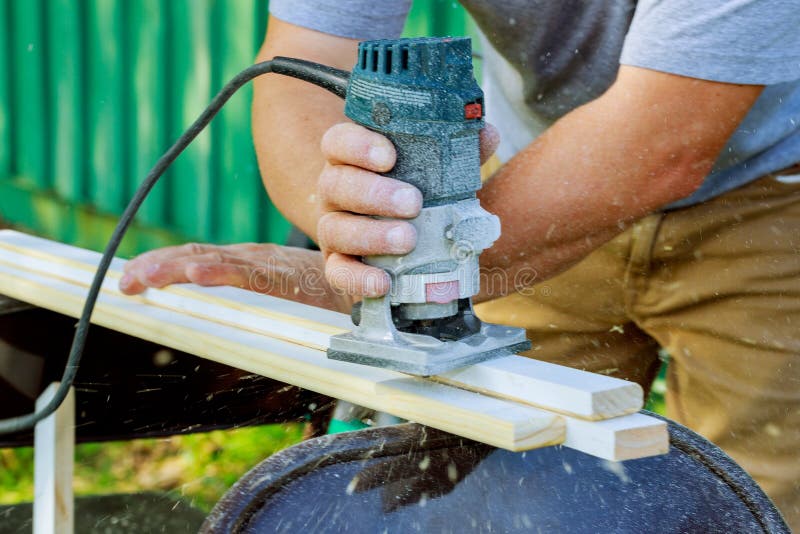 Hands of Carpenter with Electronic Plunge Router in the Hands on the ...