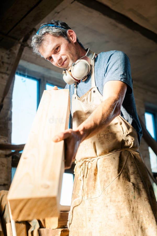 Carpenter in His Workshop Choosing Wood for the Next Project Stock ...