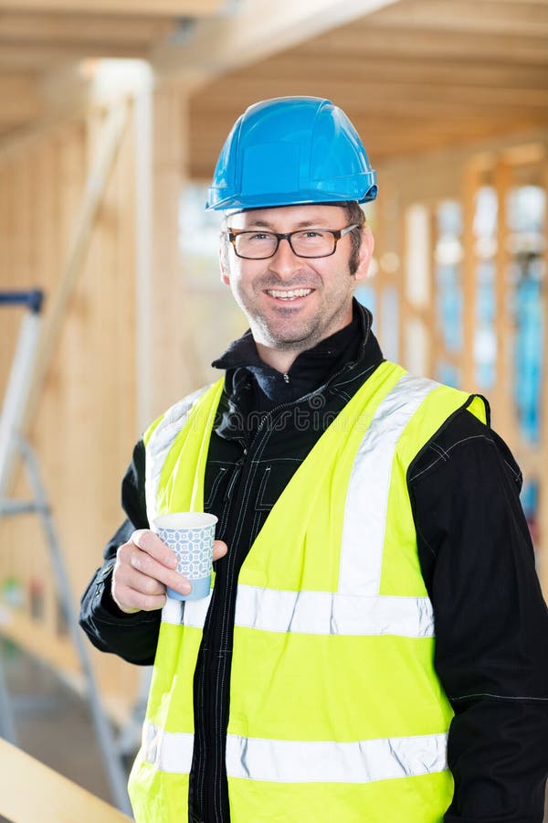 Carpenter Holding Coffee Cup at Construction Site Stock Image - Image ...
