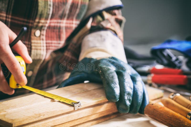 Carpenter Holding a Measure Tape Stock Photo - Image of hardware ...