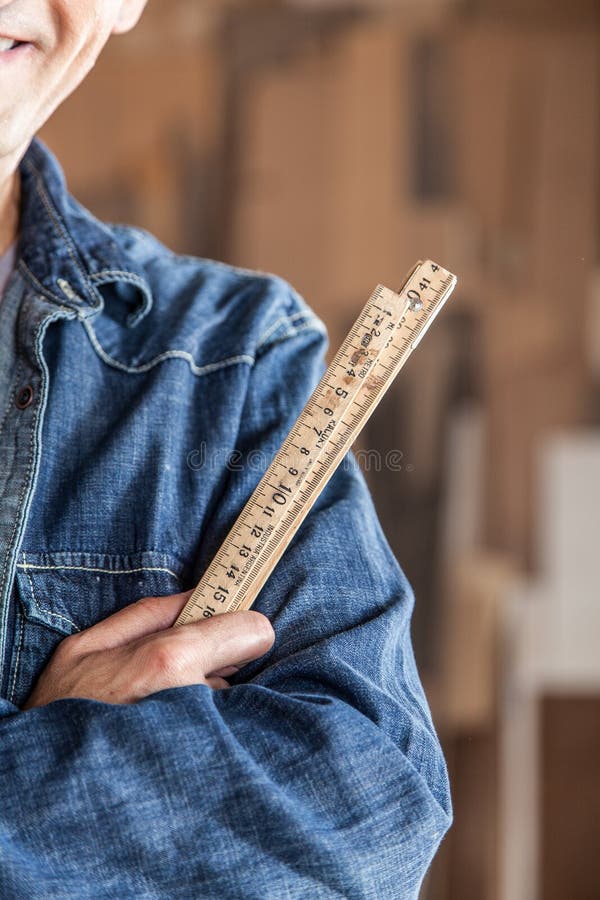 Carpenter holding a ruler stock image. Image of design - 65256405