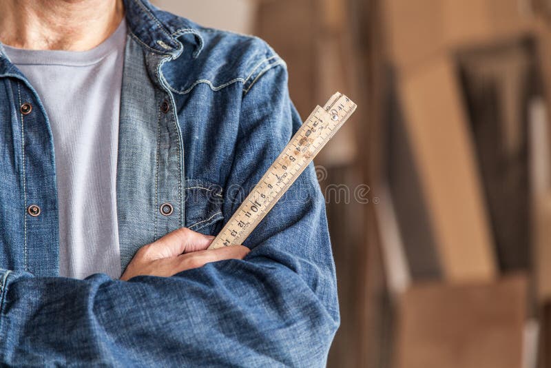 Carpenter holding a ruler stock image. Image of working - 65257049
