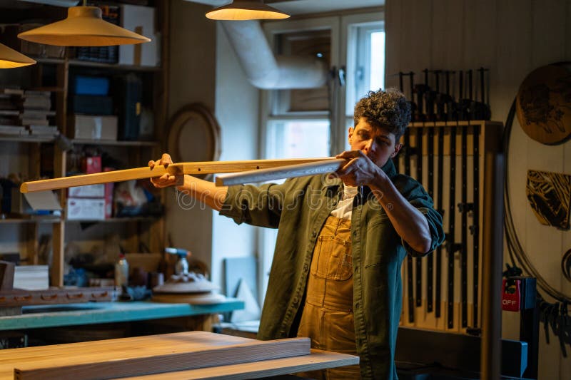 Craftsman Inspects Table Legs and Base, Ensuring Even Surfaces and ...