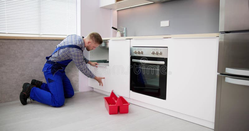 Carpenter Installing and Assembling Kitchen Furniture Stock Photo ...