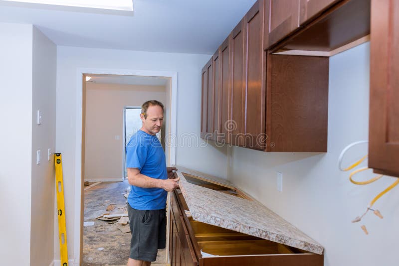 Carpenter Installing C Counter Top in a Kitchen Stock Photo - Image of ...