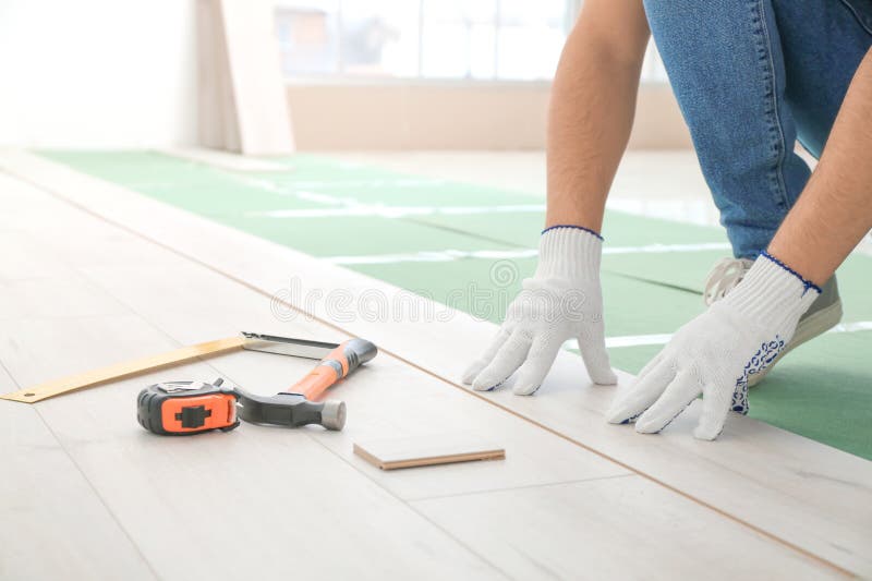 Carpenter Installing Laminate Flooring in Room Stock Image - Image of ...