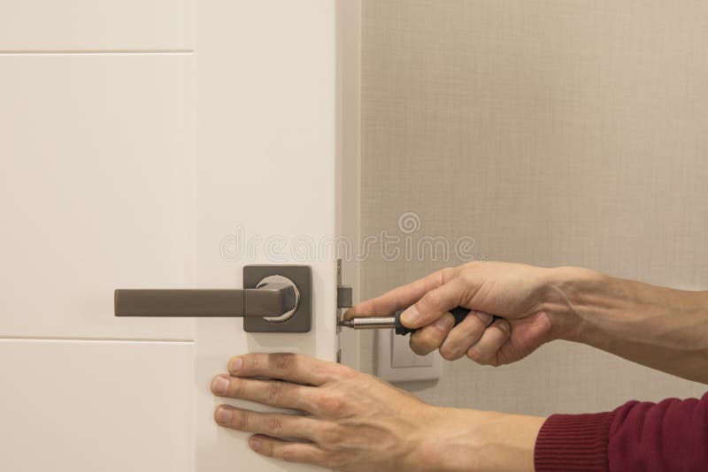Carpenter Installing the Lock on the Door Installation of the Door Lock ...